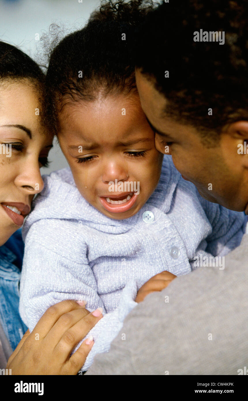 Close-up of parents consoling their crying daughter Stock Photo - Alamy