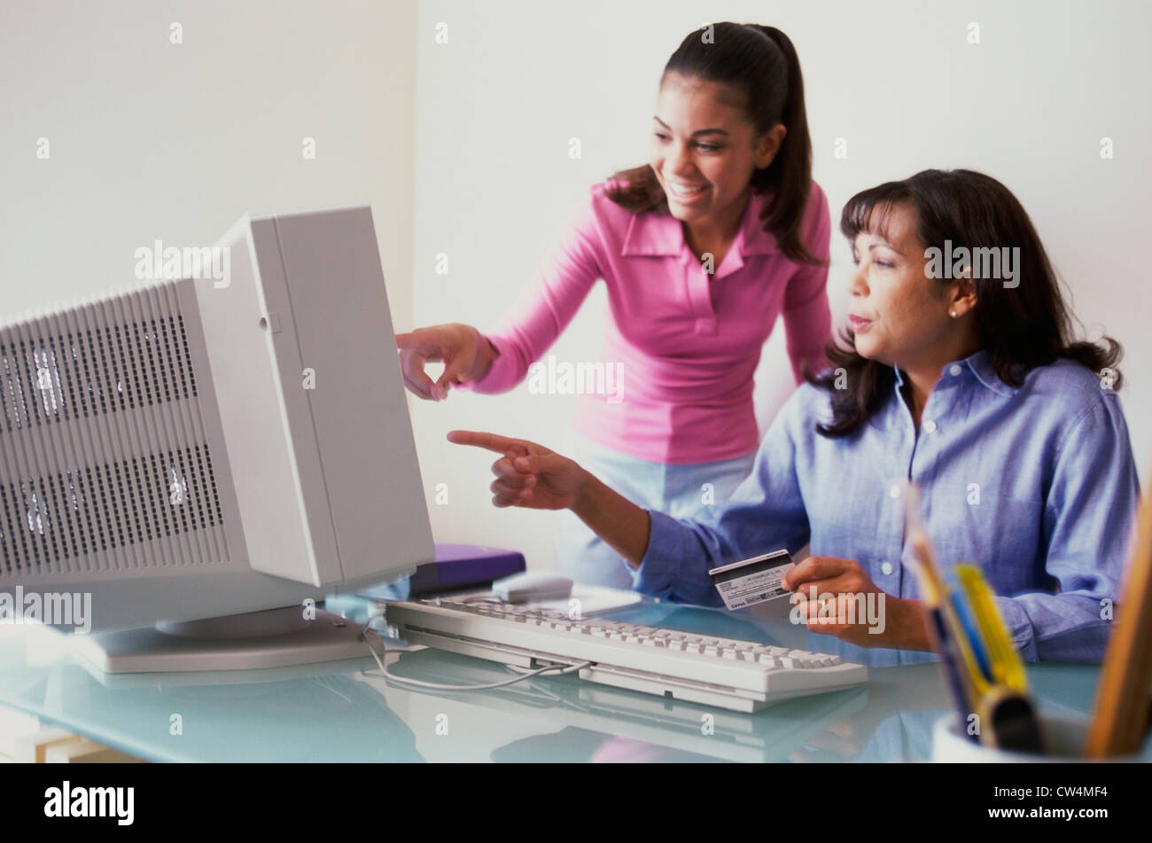Mother and her daughter using a computer Stock Photo - Alamy