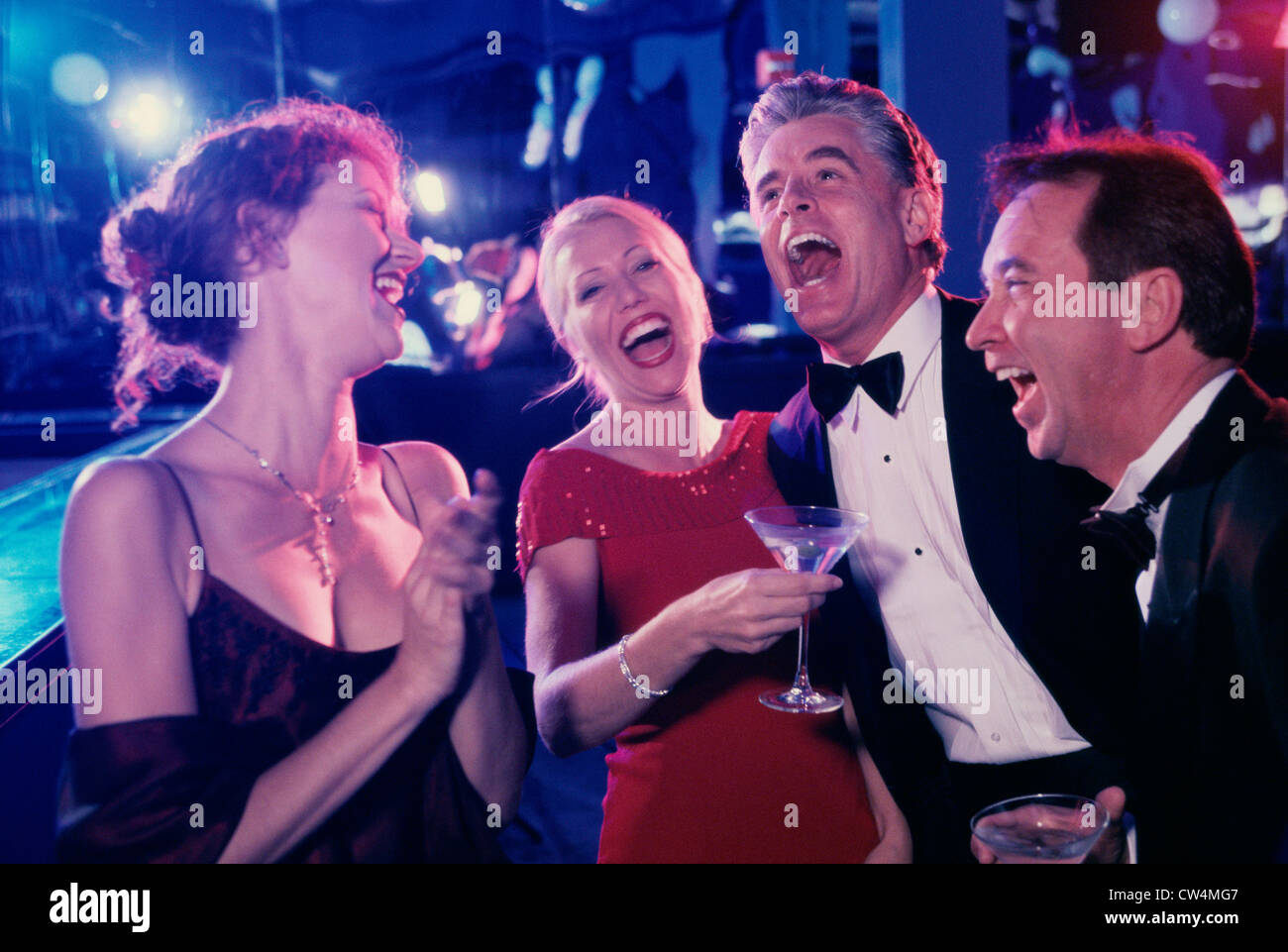 Two couples laughing Stock Photo - Alamy