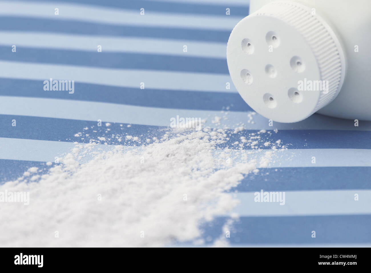 Spilled baby scented powder on striped background with short depth of ...