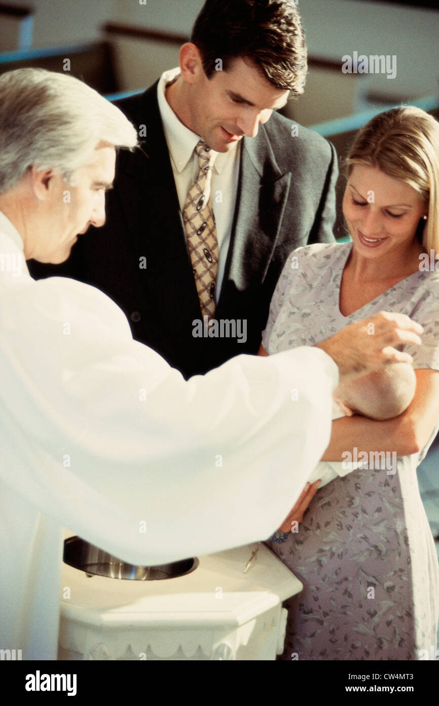 Parents with their son at a baptism Stock Photo - Alamy