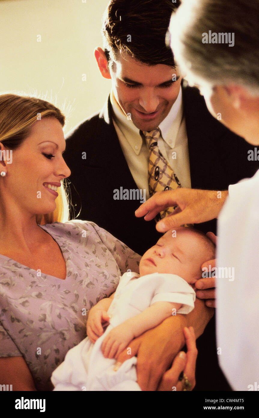 Parents with their son at a baptism Stock Photo - Alamy