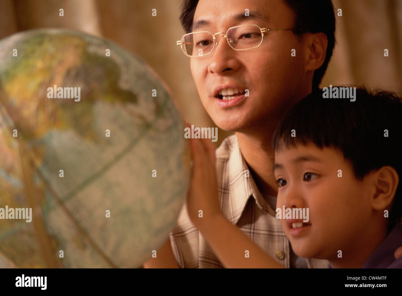 Close-up of a father teaching his son Stock Photo - Alamy