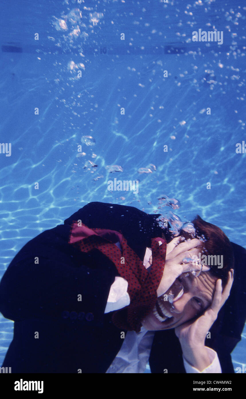 Businessman holding his head underwater Stock Photo - Alamy