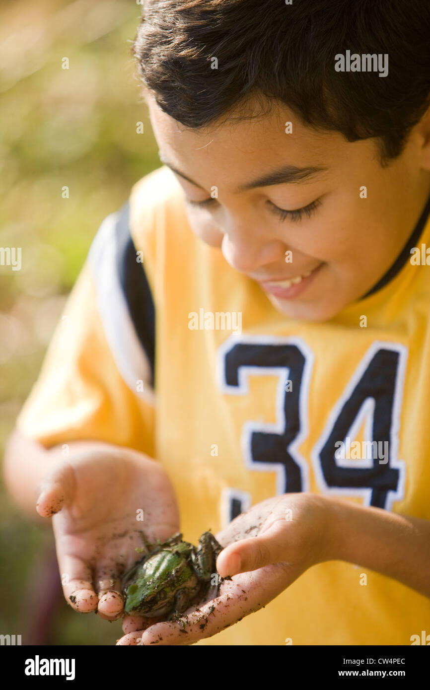 Boy holding a frog in his hands Stock Photo - Alamy