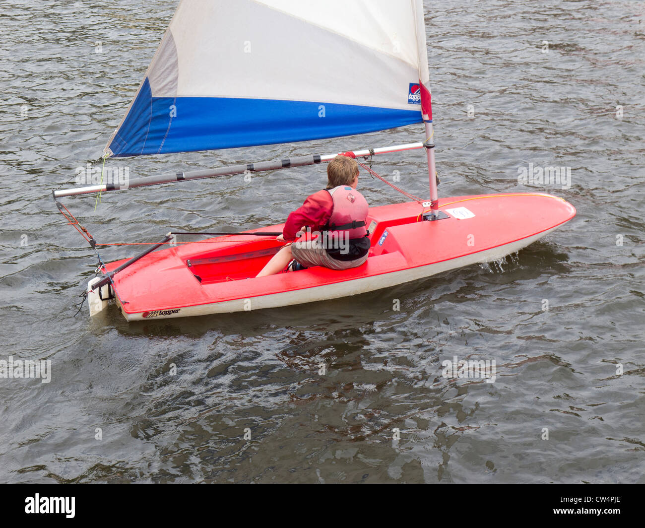 Young boy learning sailing skills in a dinghy Stock Photo - Alamy
