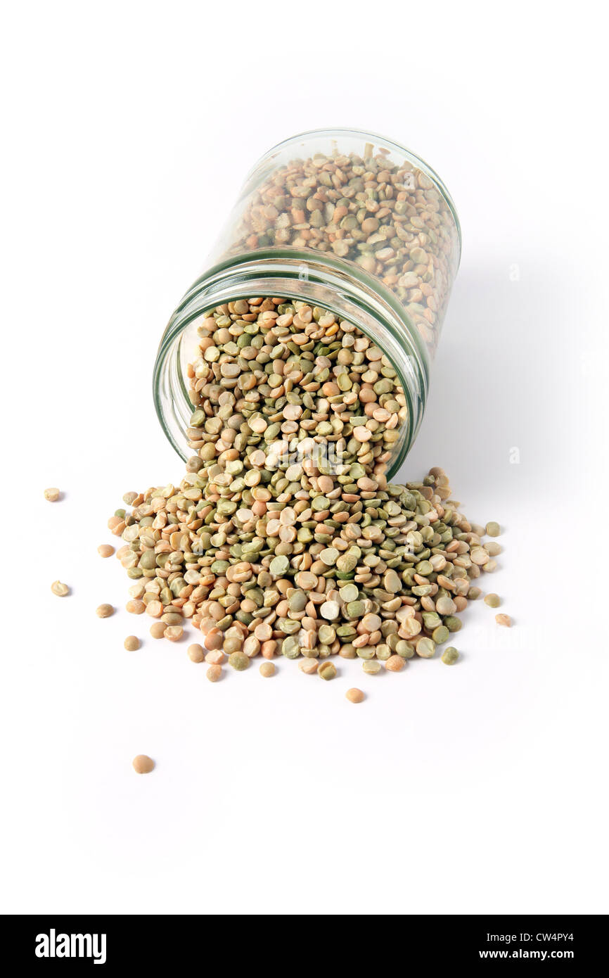 Dried lentil spilling from glass jar Stock Photo - Alamy