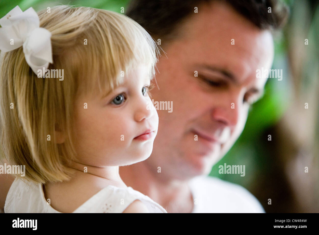 Portrait of a girl with her father in the background Stock Photo - Alamy