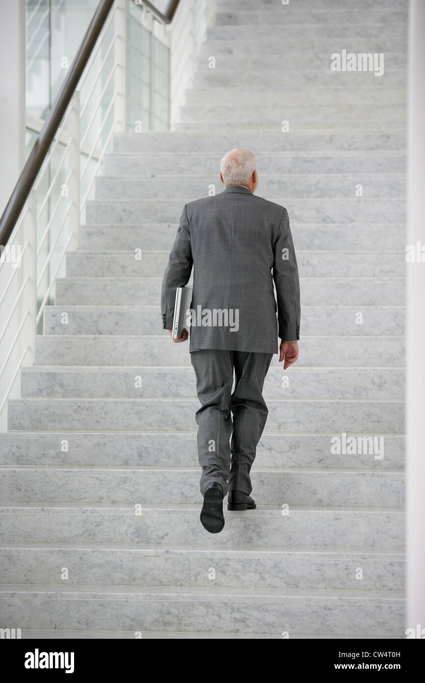 senior businessman climbing the stairs Stock Photo - Alamy