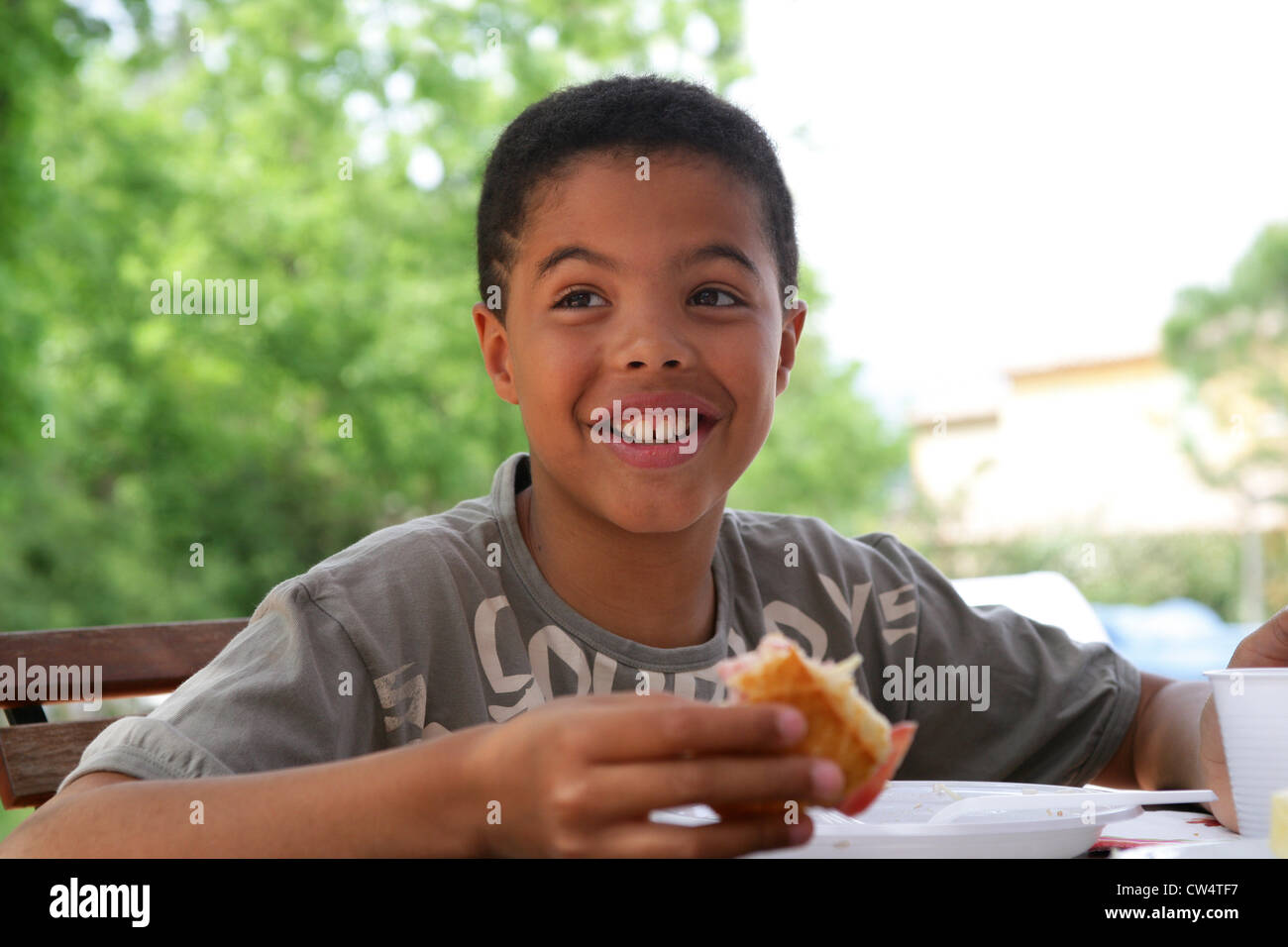 Child eating breakfast outside Stock Photo - Alamy