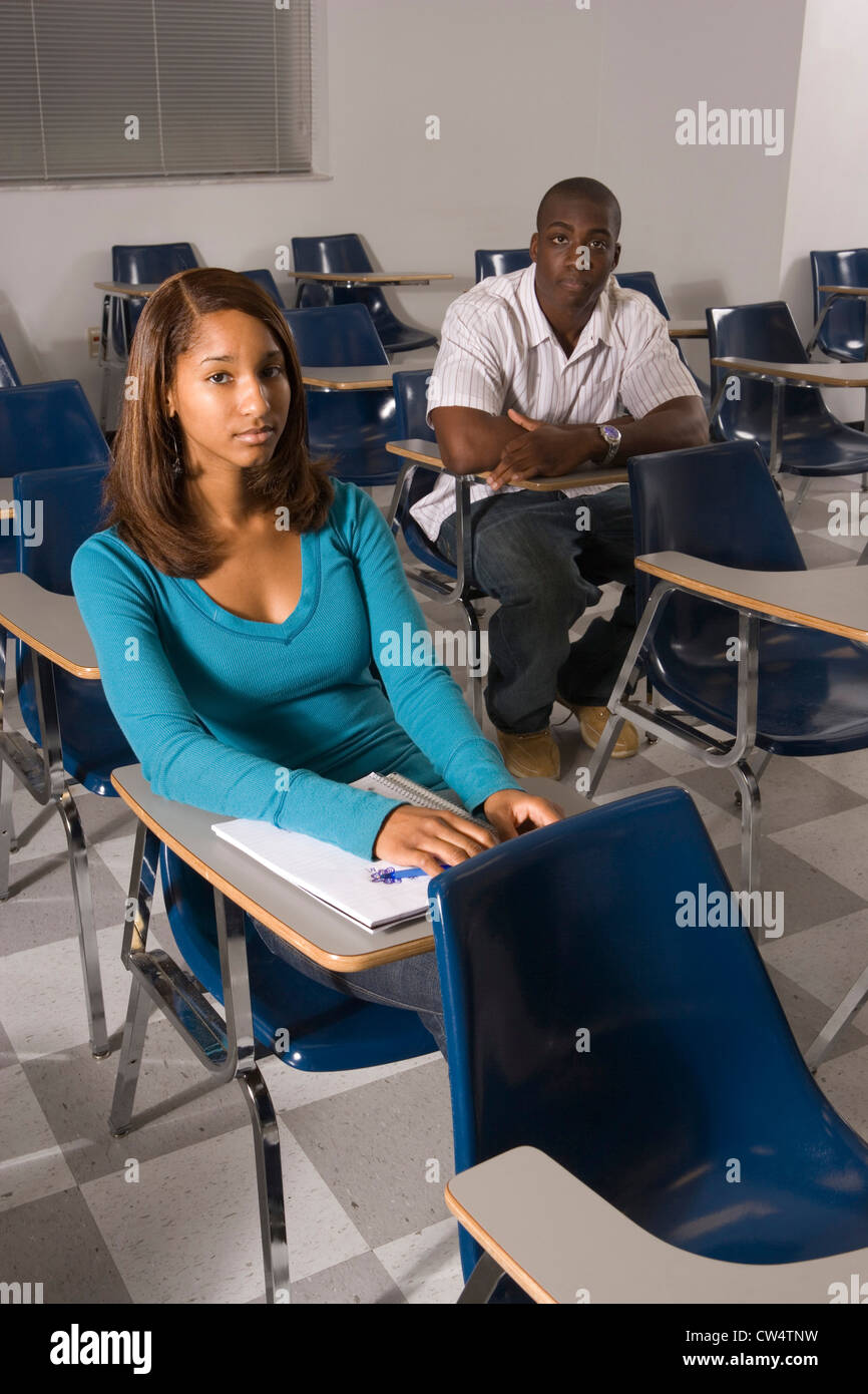 Portrait of university students attending lecture in the classroom ...