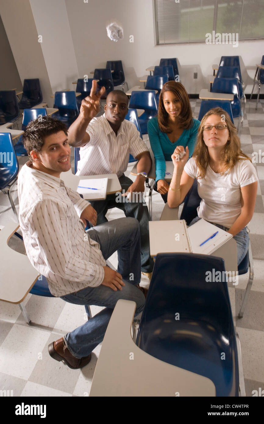 Portrait of university students in the classroom while one student ...