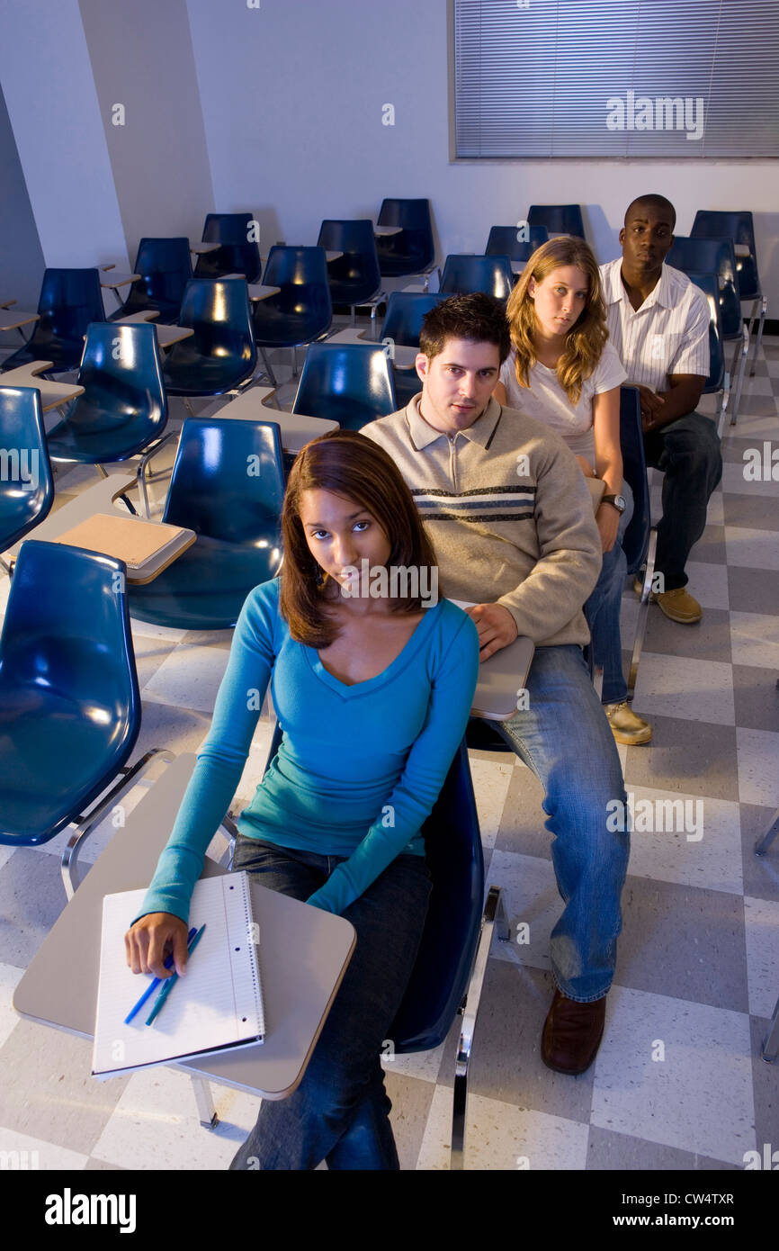 Portrait of university students attending lecture in the classroom ...