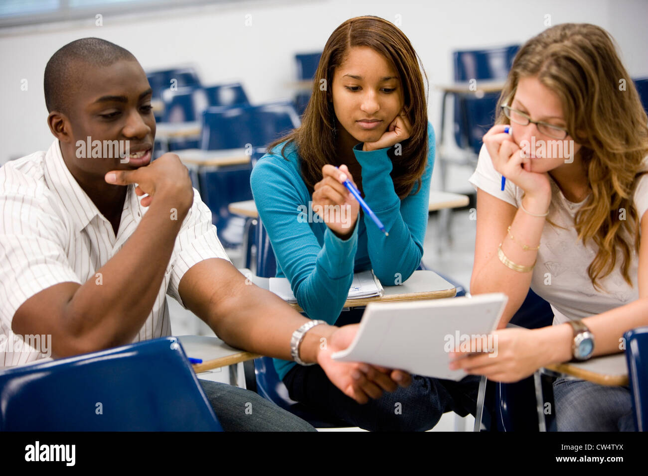 University students discussing with a book in the classroom Stock Photo ...