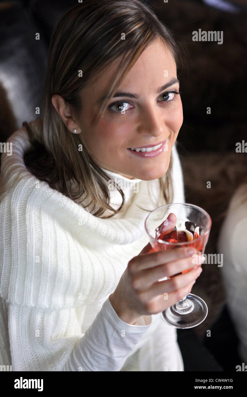 Attractive woman drinking a cocktail Stock Photo - Alamy