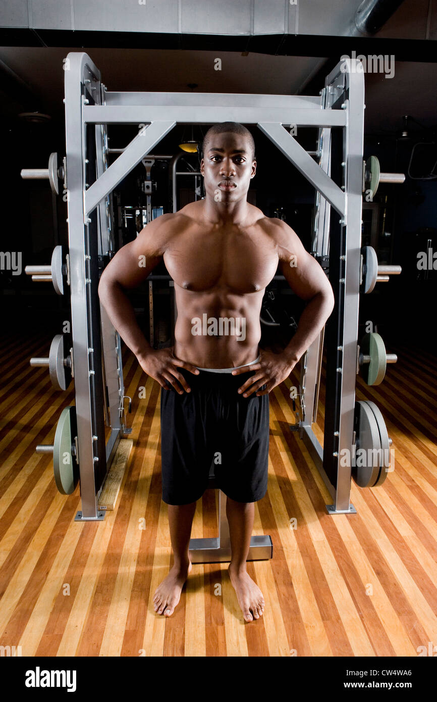 Portrait of a shirtless young man standing in the gym Stock Photo - Alamy