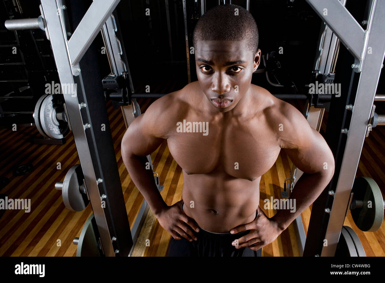 Portrait of a shirtless young man standing in the gym Stock Photo - Alamy