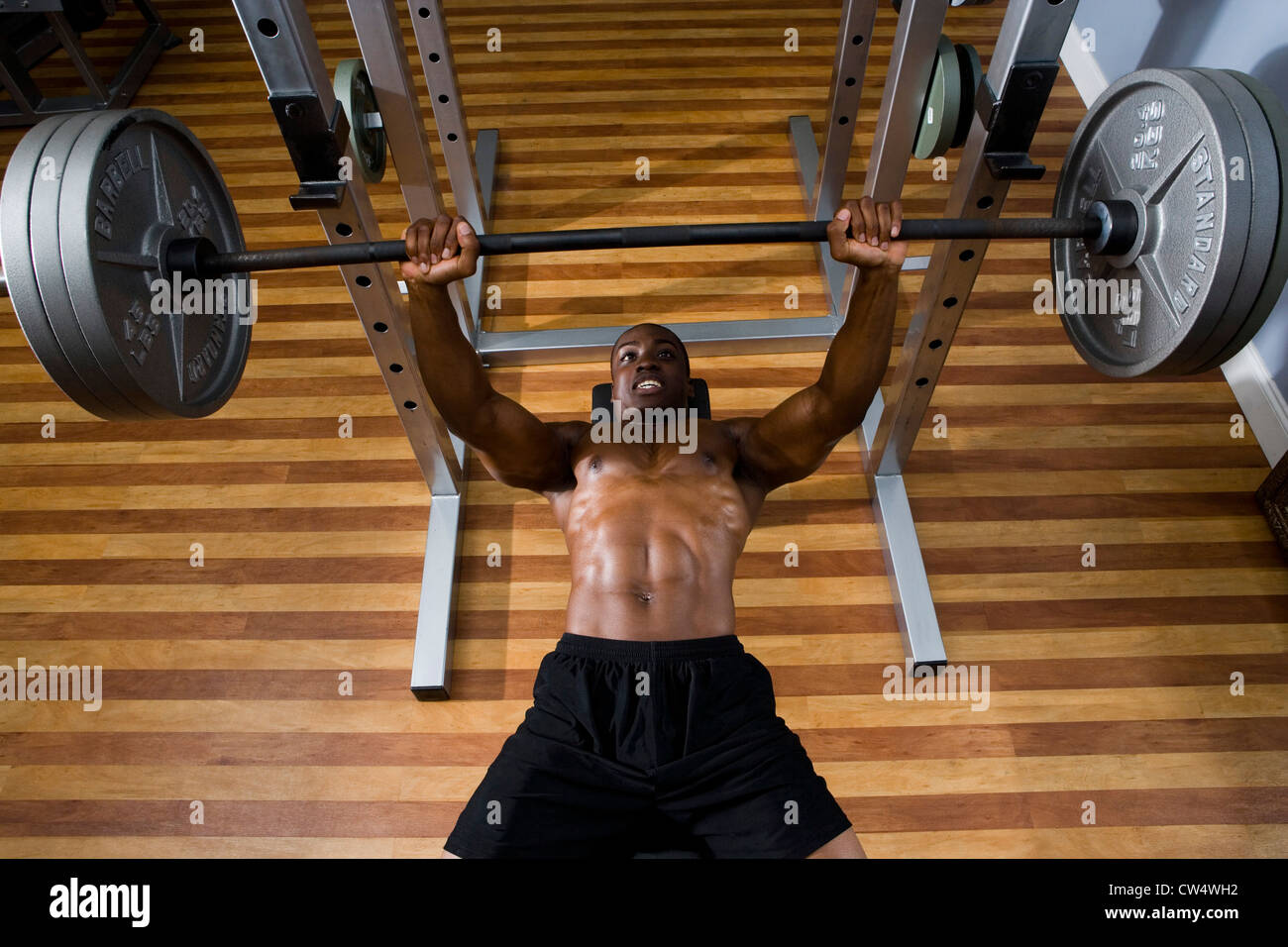 Elevated view of a young man bench-pressing barbell in the gym Stock ...