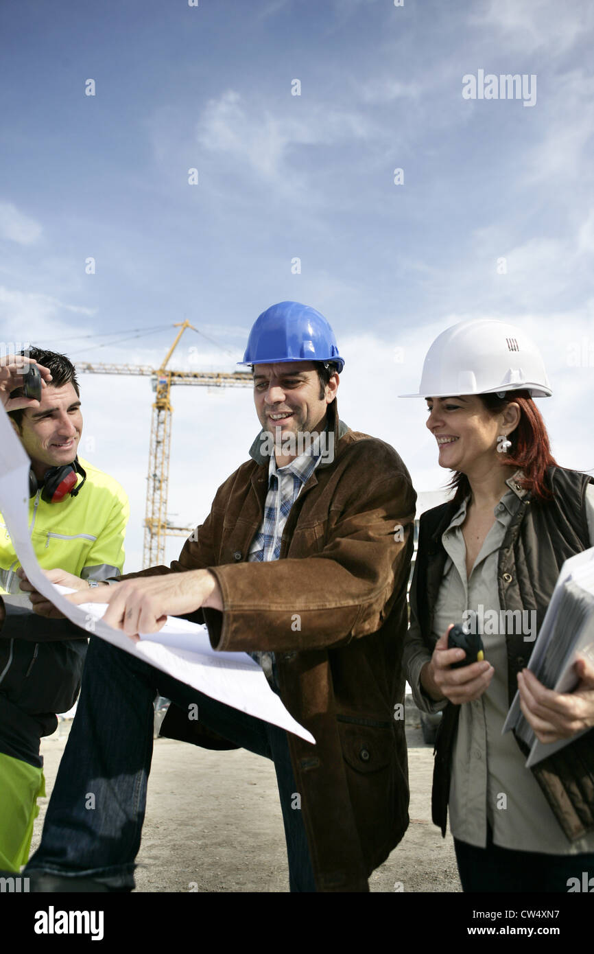 Teamwork on a building site Stock Photo - Alamy
