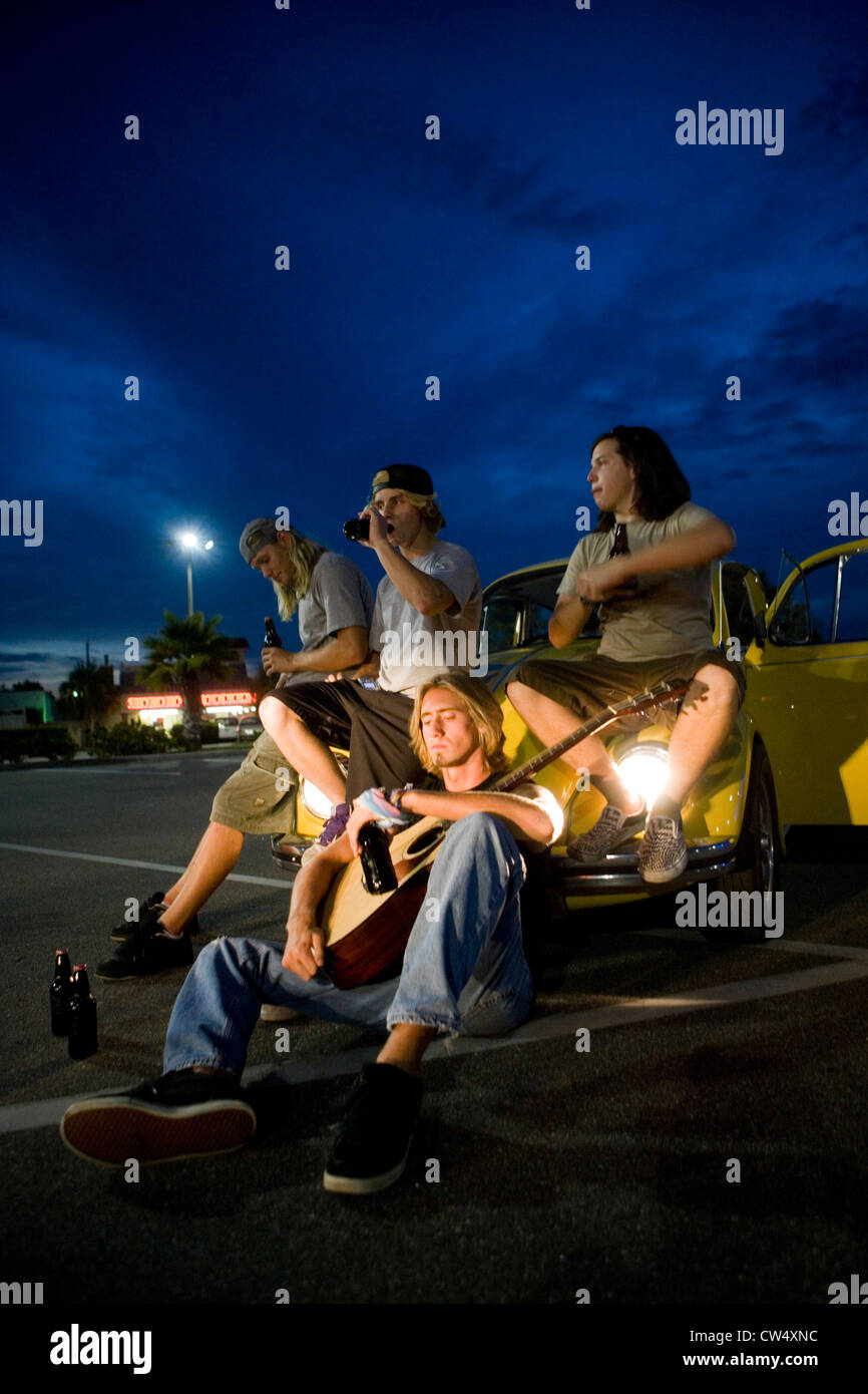Friends drinking by a car at the parking area Stock Photo - Alamy