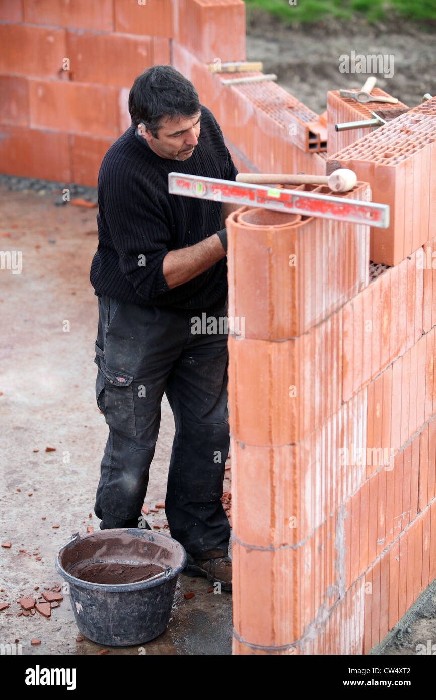 Mason working on site alone Stock Photo - Alamy