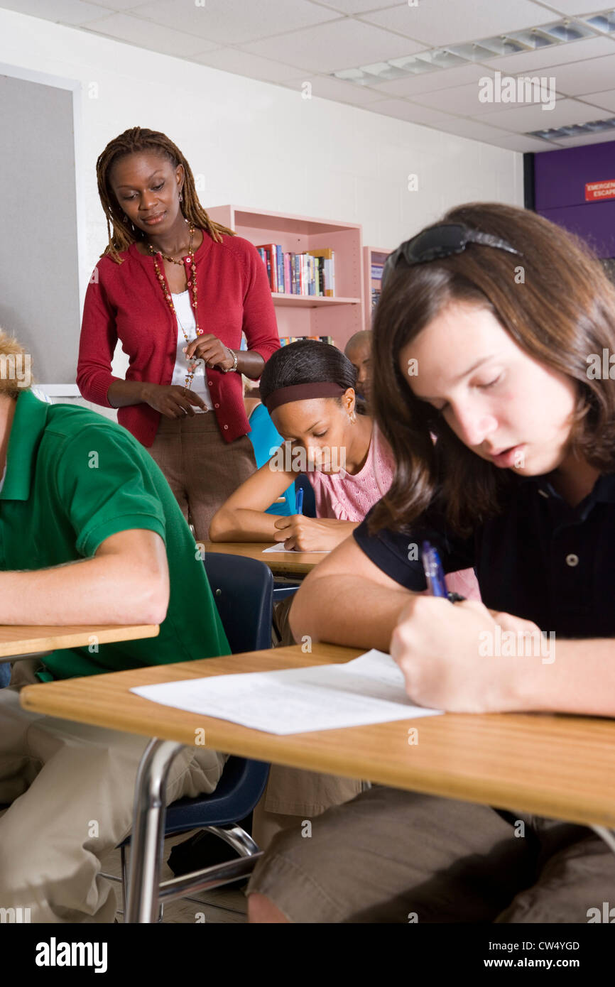 Female teacher supervising during exam in the classroom Stock Photo - Alamy