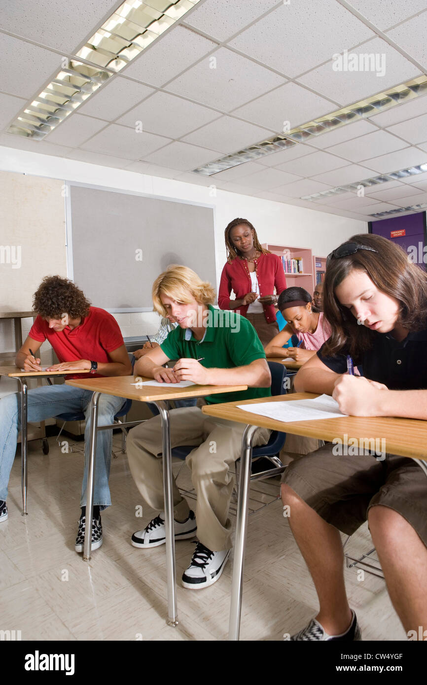 Female teacher supervising during exam in the classroom Stock Photo - Alamy