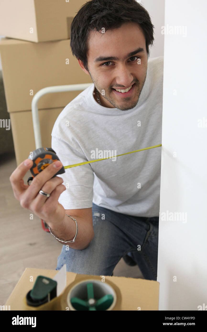 Man measuring wall Stock Photo - Alamy