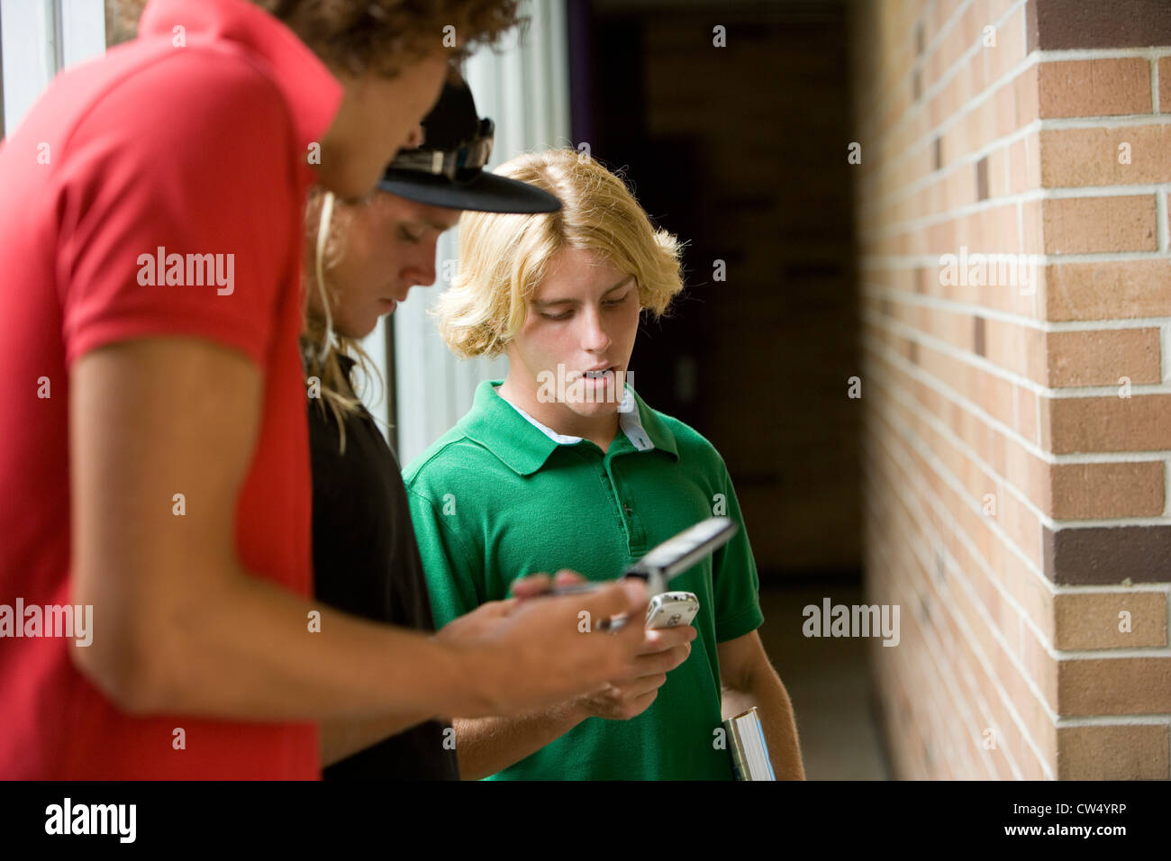 Three students standing school corridor hi-res stock photography and ...