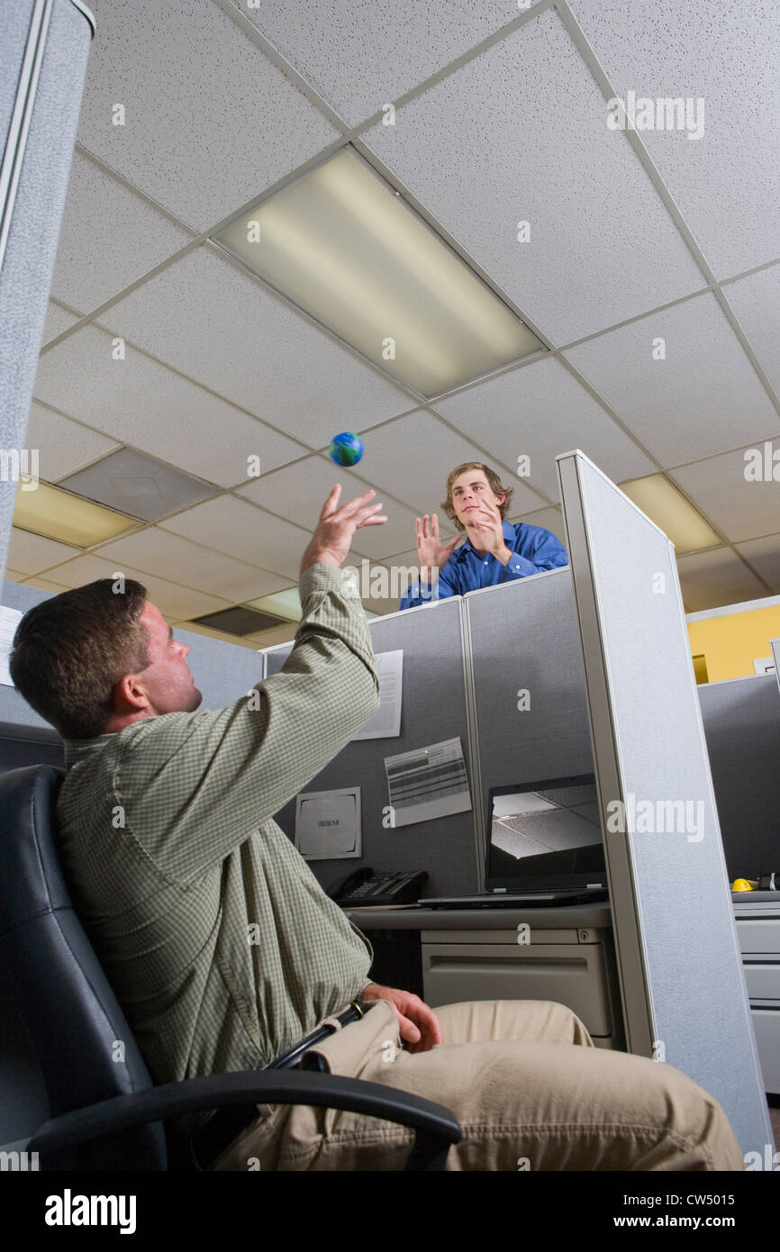 Businessmen playing with a ball in an office Stock Photo - Alamy