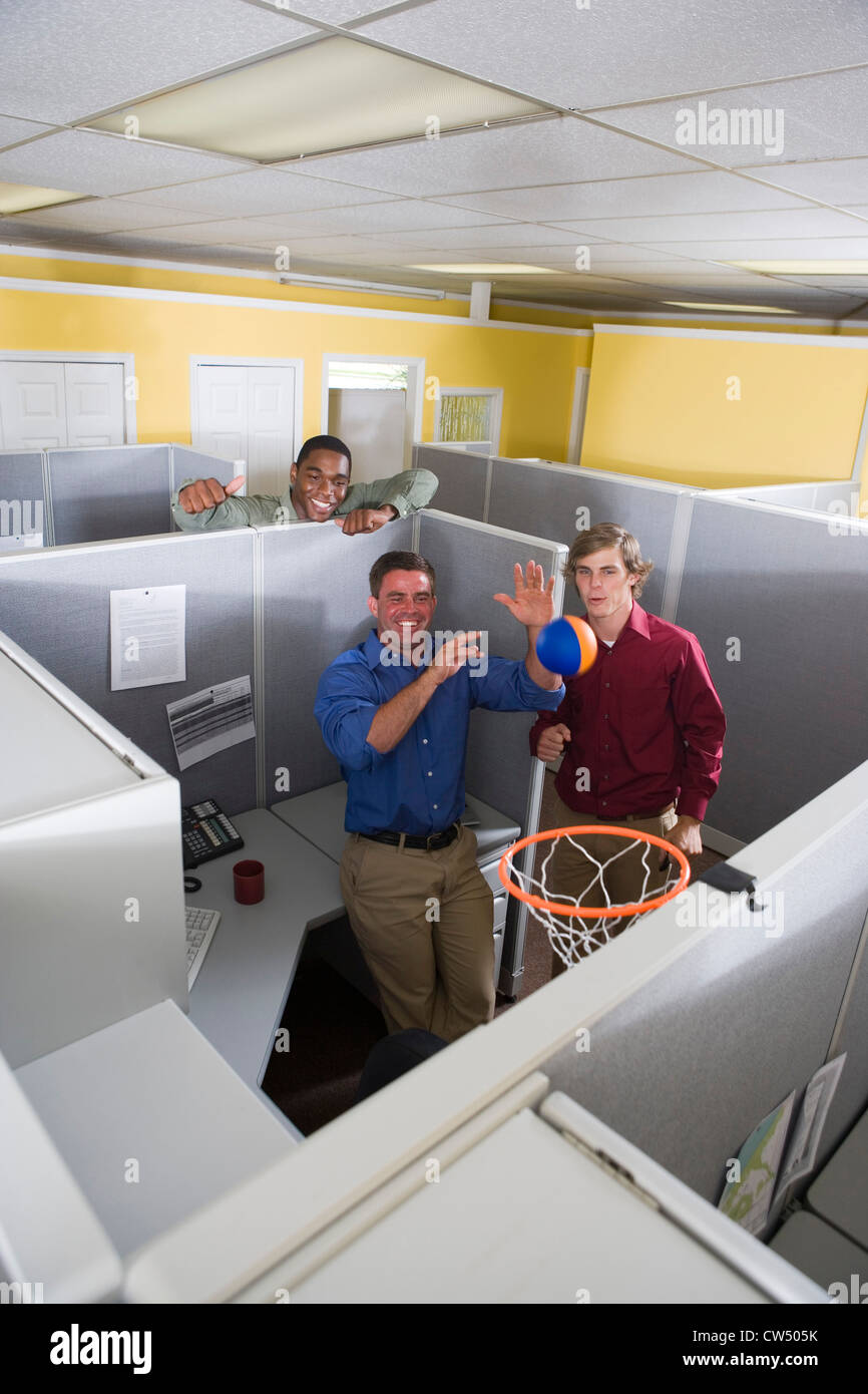Businessmen playing with ball in an office Stock Photo - Alamy