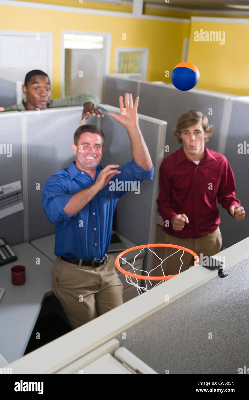 Businessmen playing with ball in an office Stock Photo - Alamy