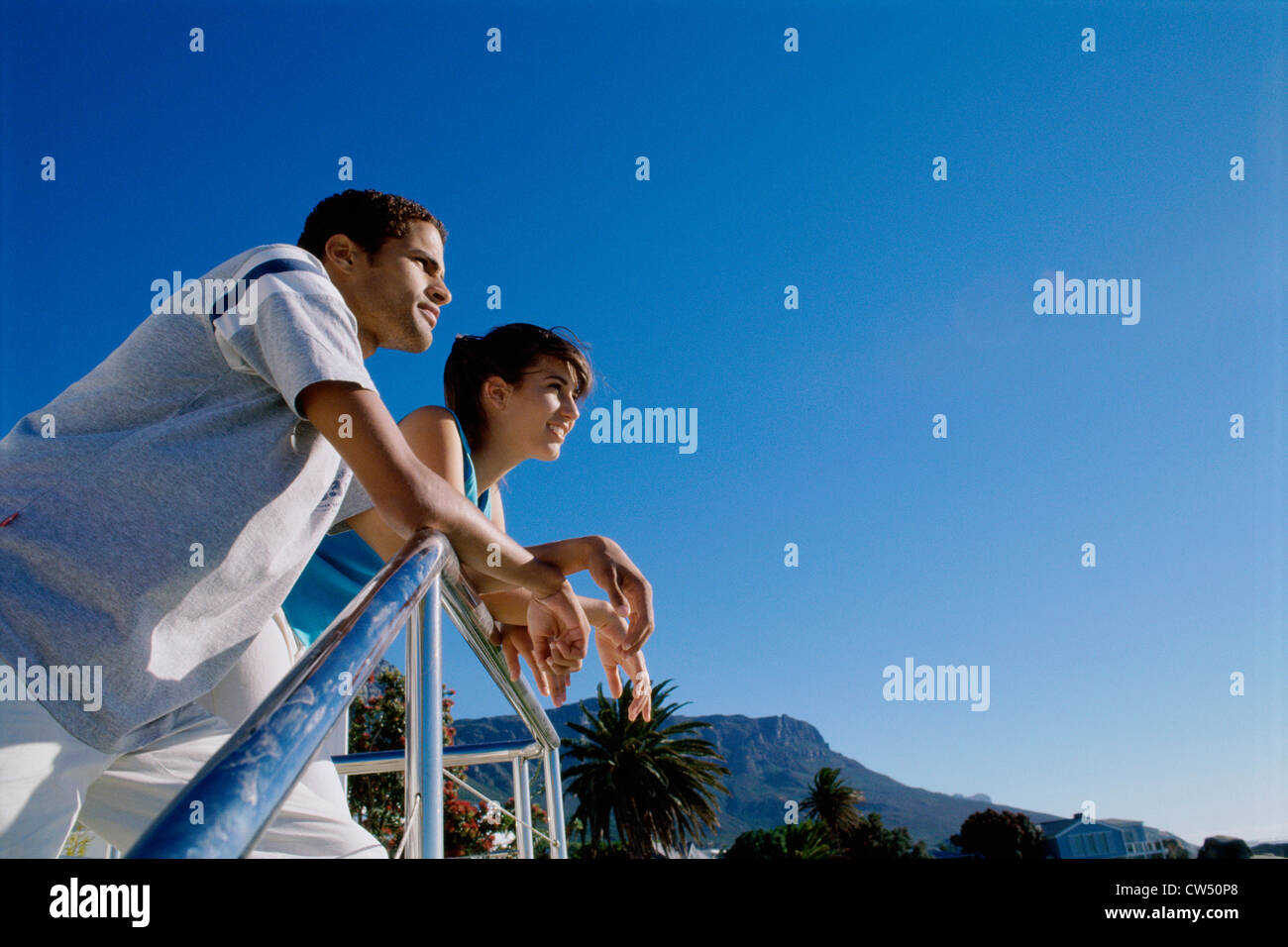 Woman leaning against rail hi-res stock photography and images - Alamy