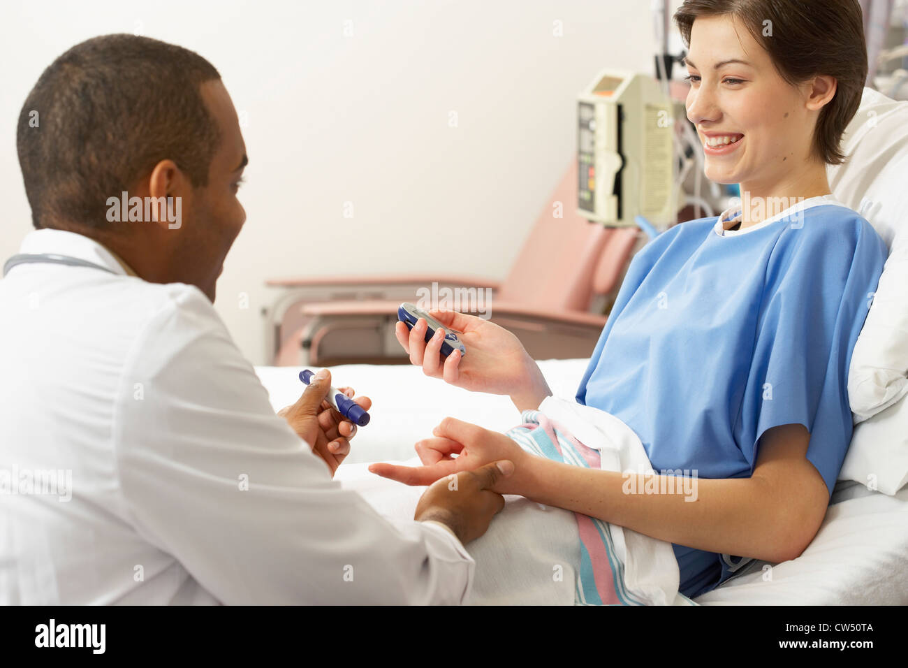 Side profile of a male doctor taking a blood sample from a female ...