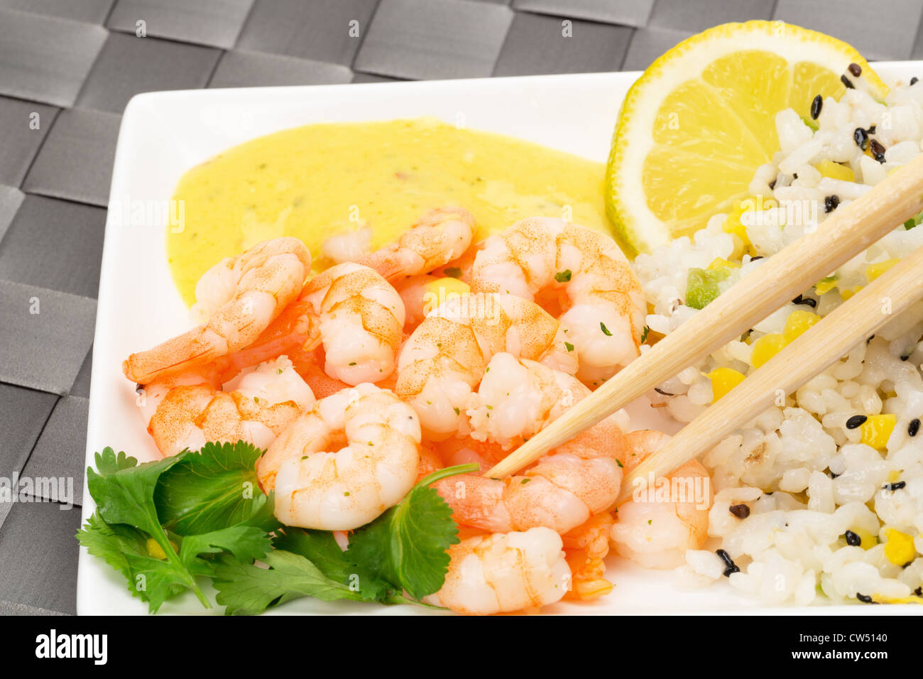 King prawn and fried rice served with a salad and coconut and mango ...
