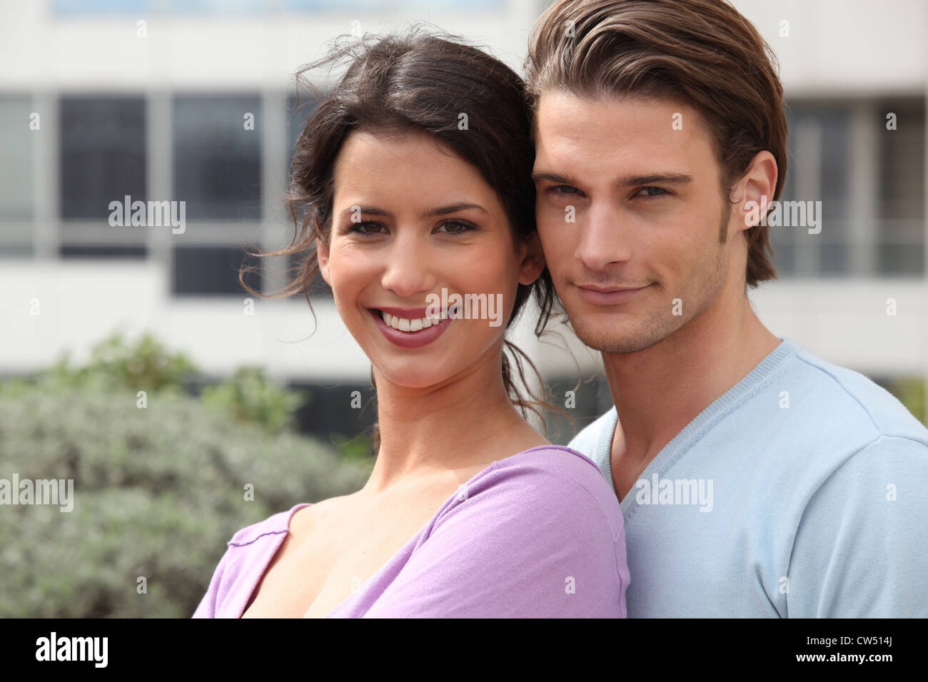 Couple stood outside apartment block Stock Photo - Alamy
