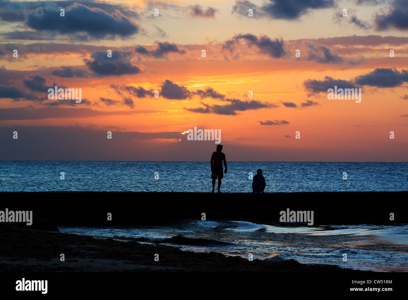 Couple watching sunset over ocean hi-res stock photography and images ...