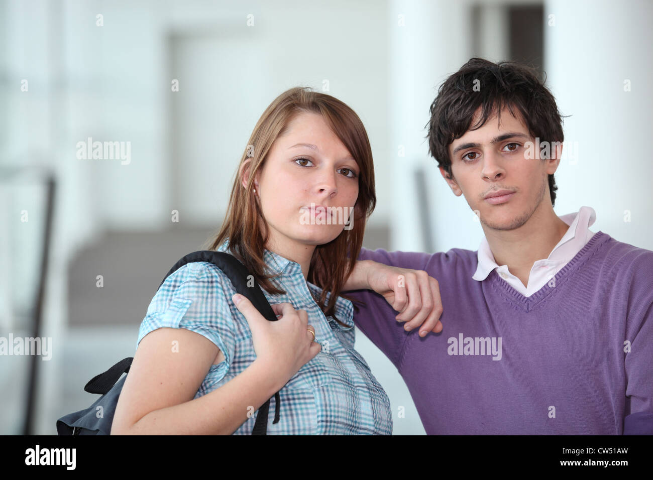 Two students stood in school corridor Stock Photo - Alamy