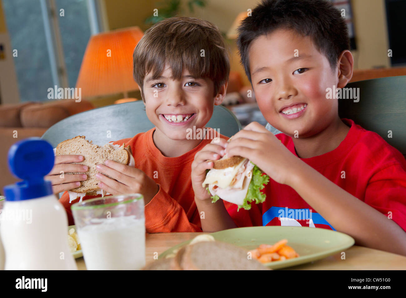 Boys eating lunch together Stock Photo - Alamy