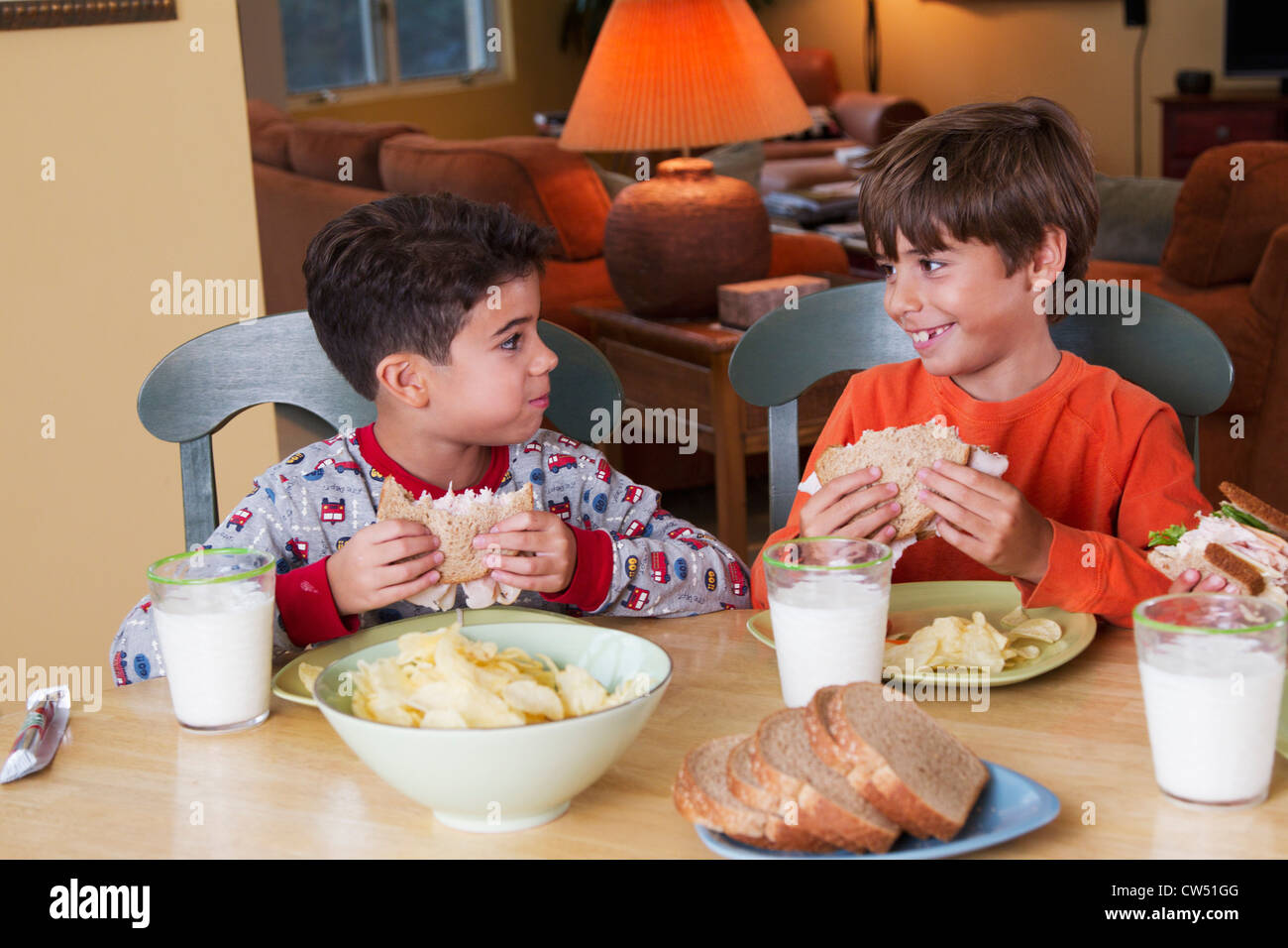 Boys eating lunch together Stock Photo - Alamy