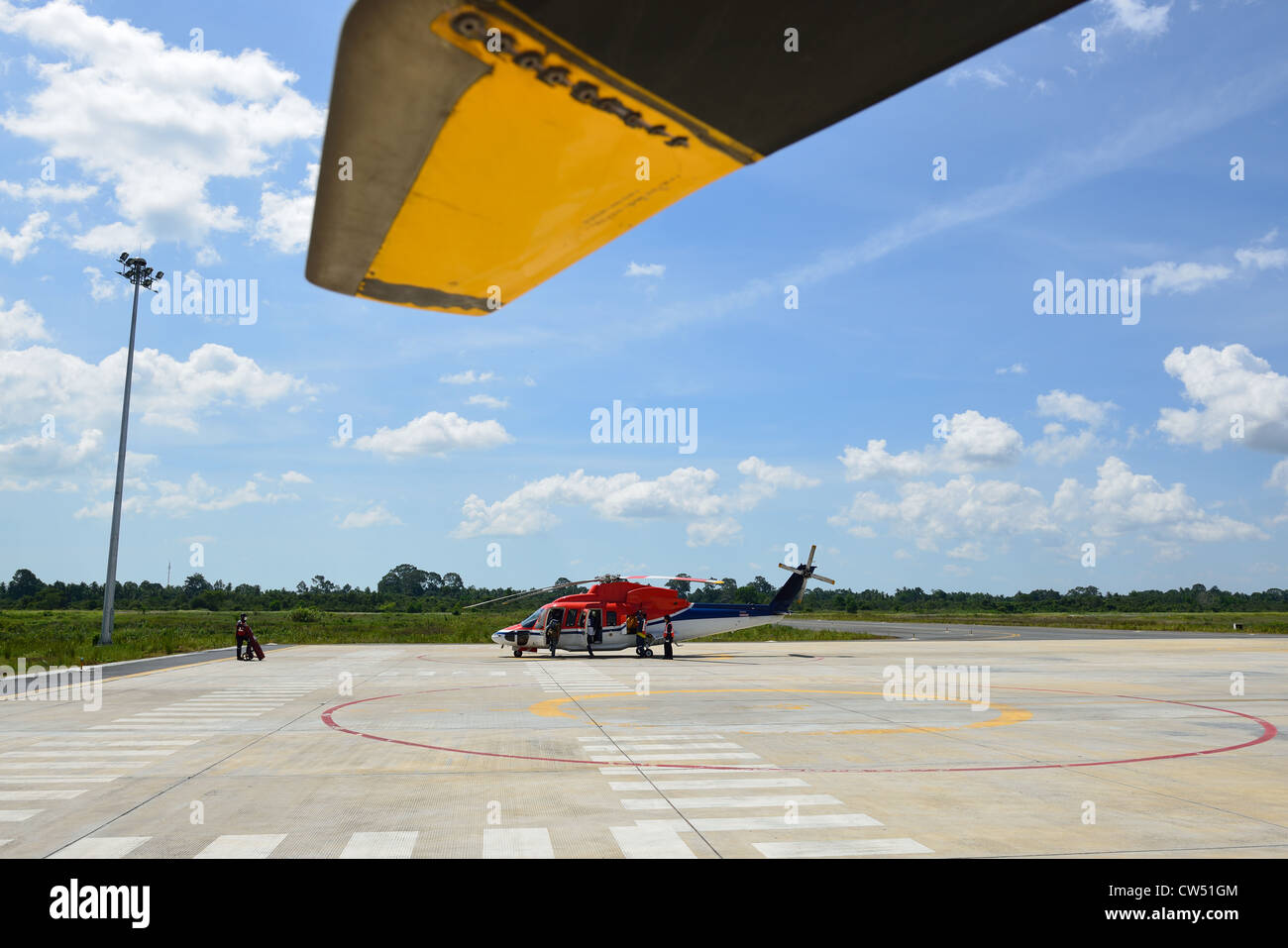 The passenger are boarding helicopter at the apron Stock Photo - Alamy