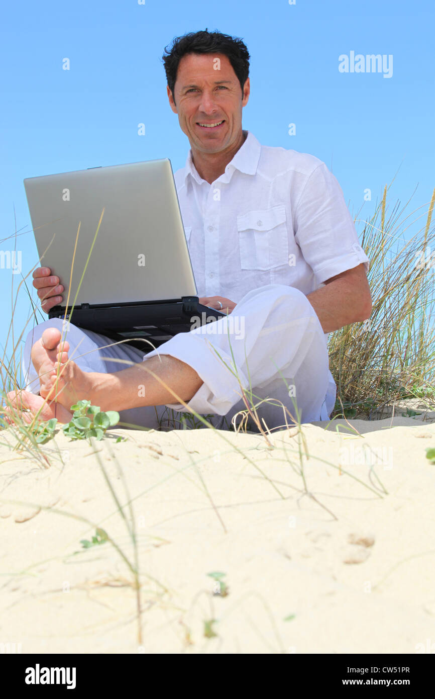 Man sitting with computer Stock Photo - Alamy