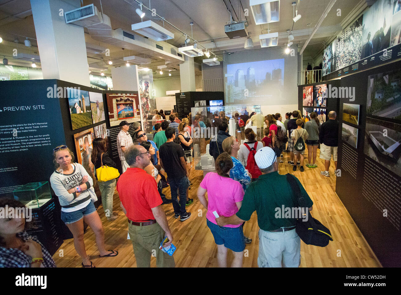 People gathered in the 9/11 Memorial Museum – inside view - watching ...
