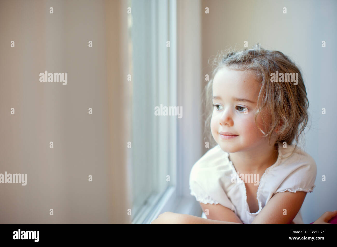 Girl looking out window Stock Photo - Alamy
