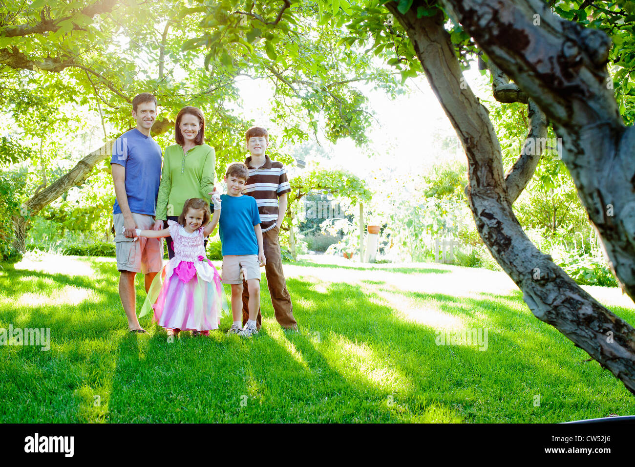 Happy family with tree children in garden Stock Photo - Alamy