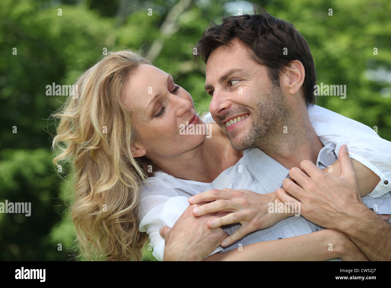 Blonde woman hugging man Stock Photo - Alamy