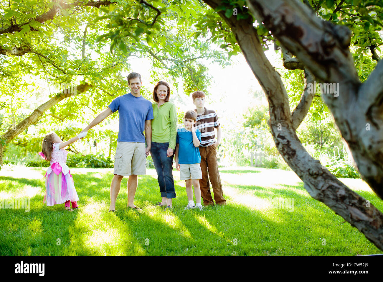 Happy family with tree children in garden Stock Photo - Alamy