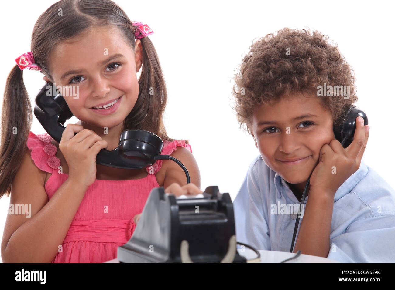 two children using an old telephone Stock Photo - Alamy