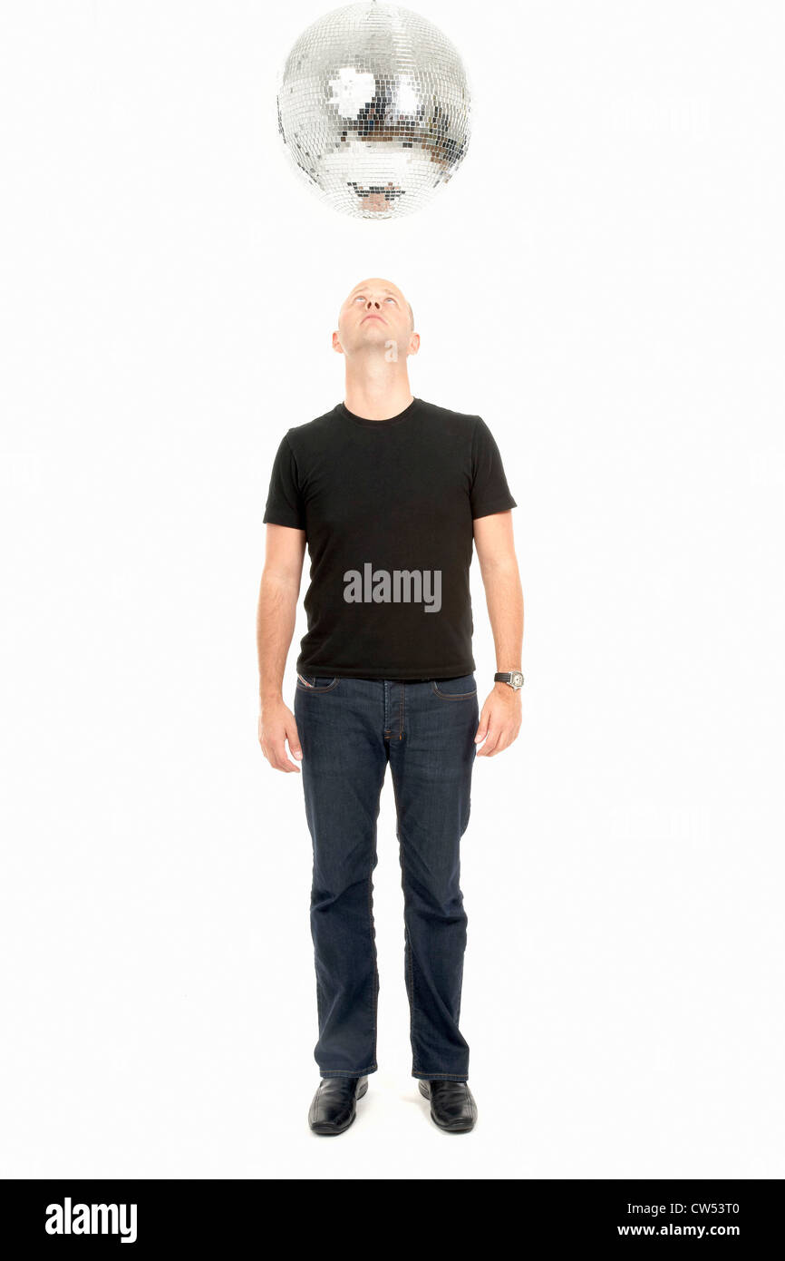 Man looking up at disco mirror ball Stock Photo - Alamy