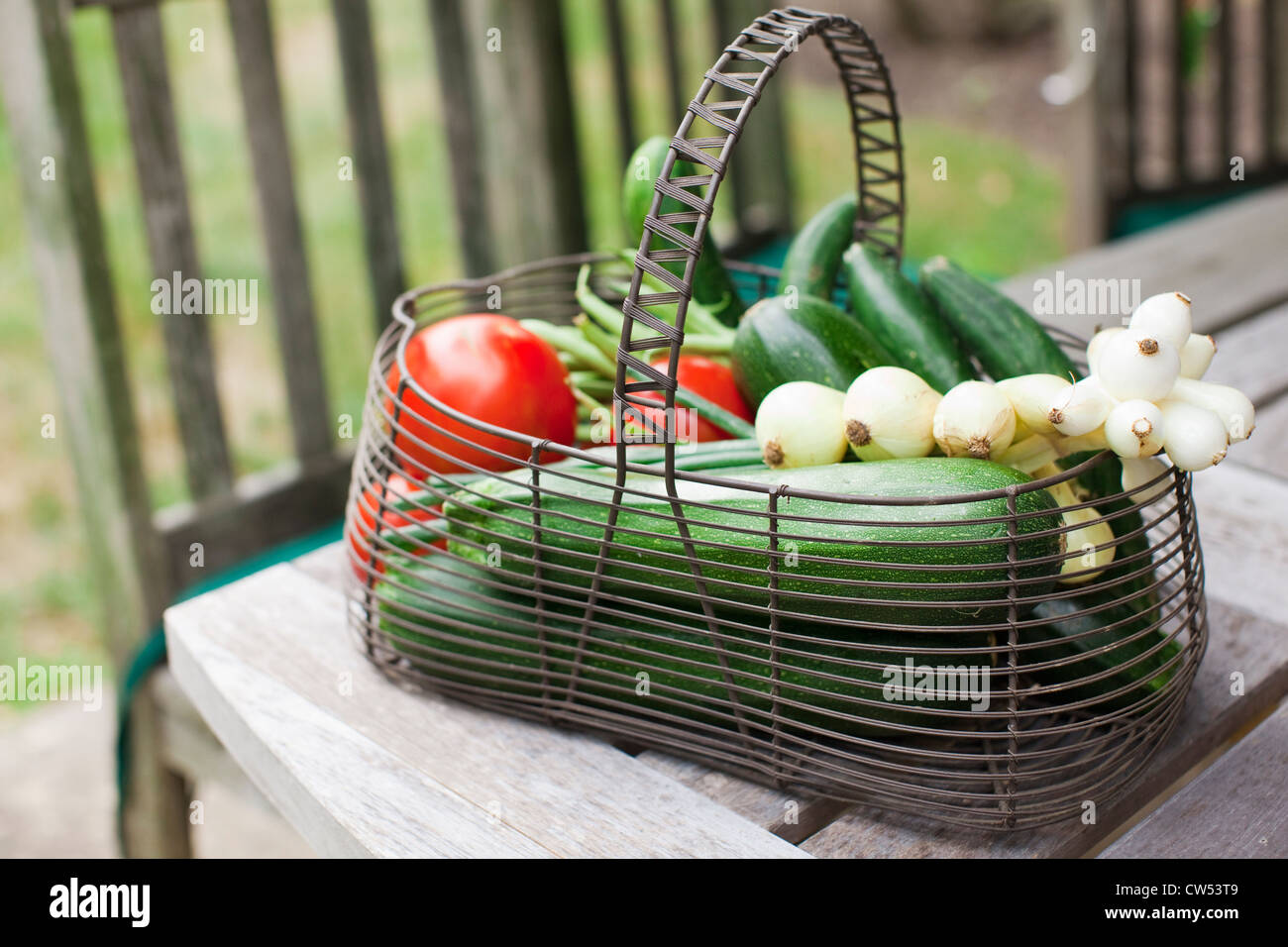 Vegetables in wire basket outdoors Stock Photo - Alamy